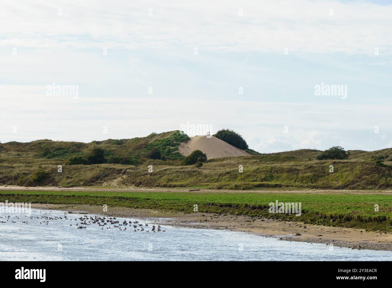 Two people stand on top of the Big Dipper, the tallest sand dune in the ...