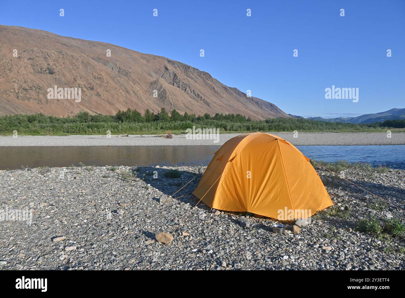 Travel to the Polar Urals. Orange tent against the backdrop of Mount ...