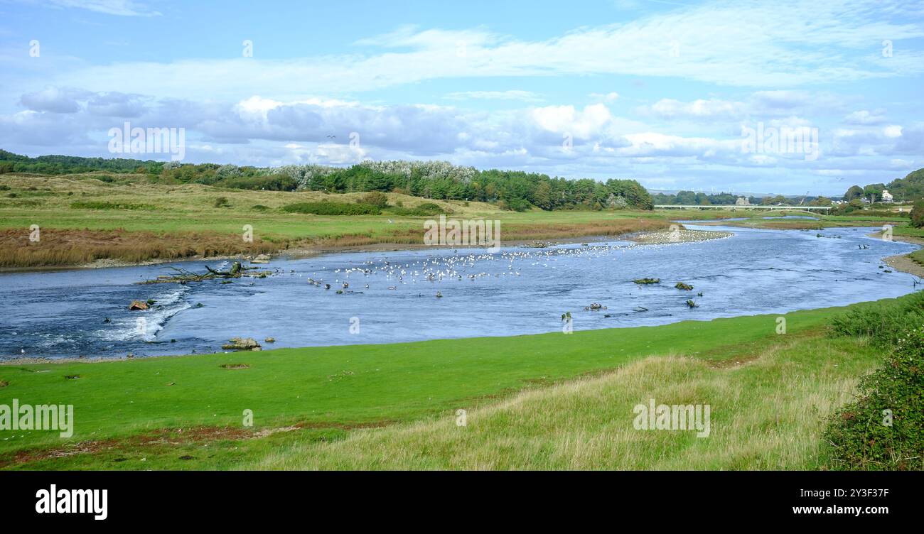 The River Ogmore, Ogmore on Sea, South Wales, flows through sand dunes ...
