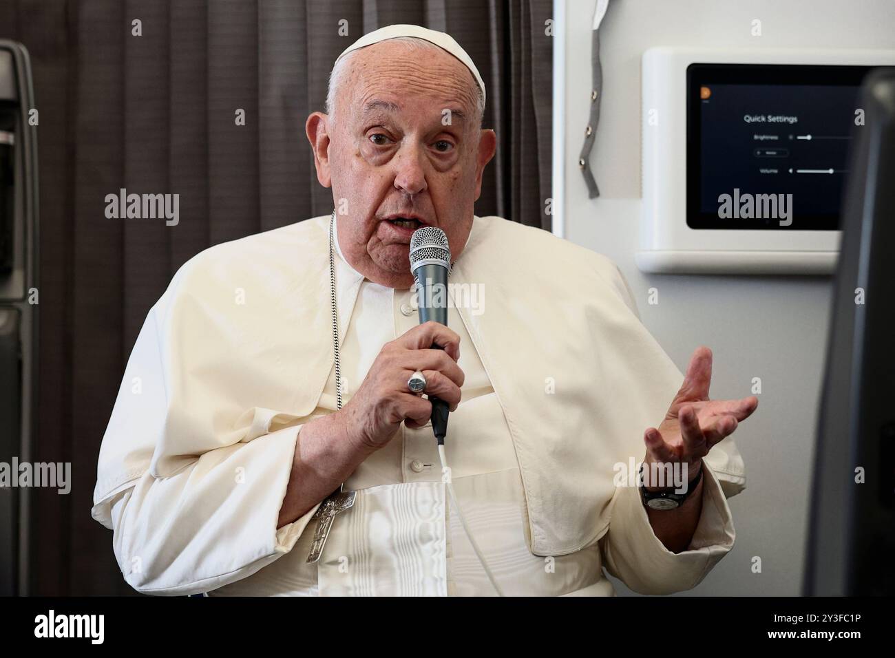 Pope Francis holds a news conference aboard the papal plane on his ...