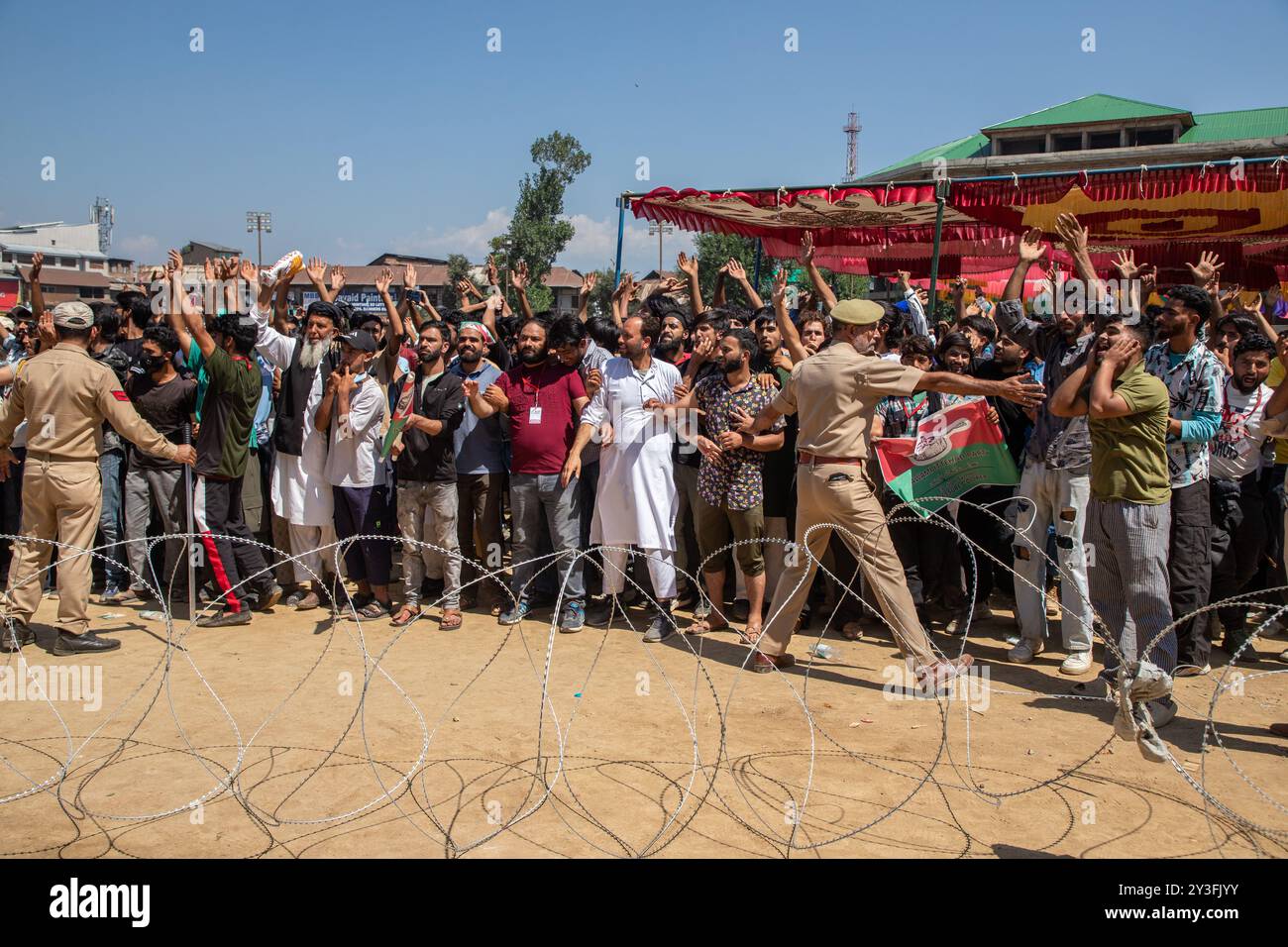 Indian police are seen controlling the crowd as member of the Indian ...