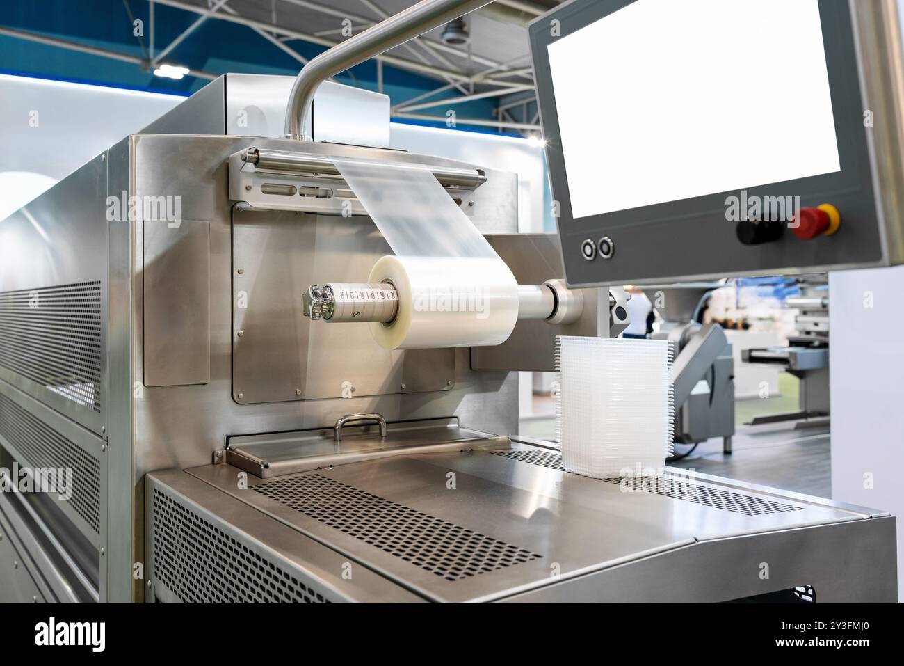 Plastic film, packaging industrial machine in factory. Roll of ...