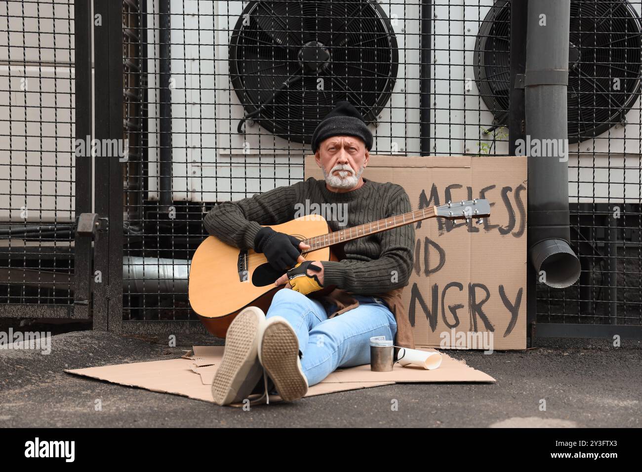 Homeless man playing guitar hi-res stock photography and images - Alamy