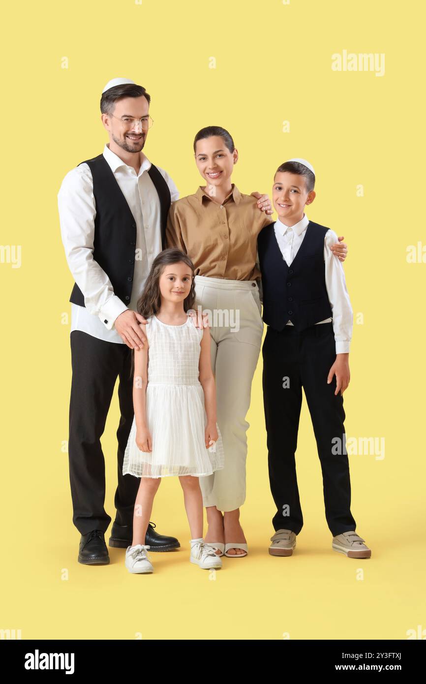 Happy Jewish family on yellow background Stock Photo - Alamy
