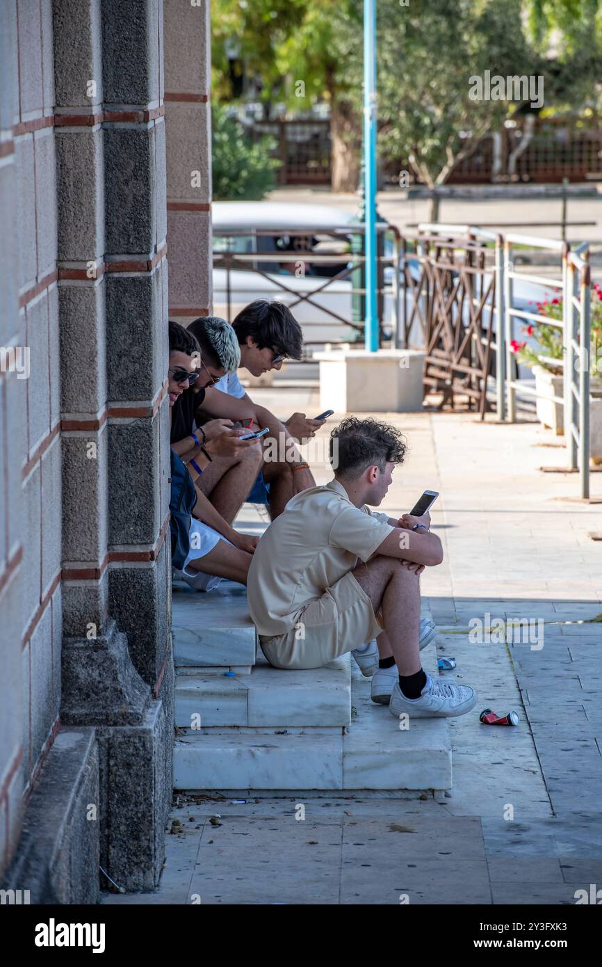group of teenage boys all looking at smartphone, kids with mobile ...