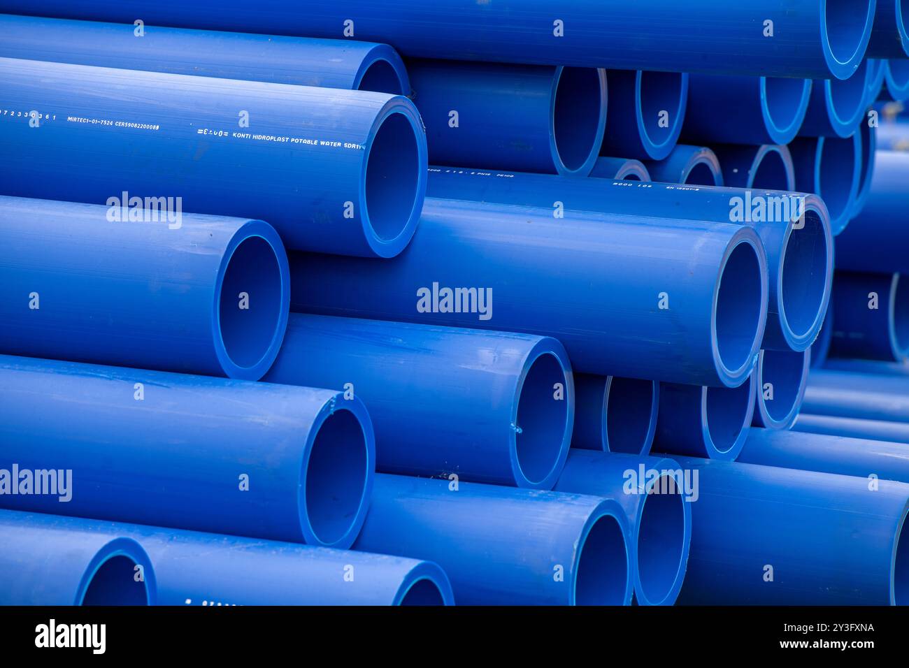 abstract image of blue plastic pipes, stack of blue plastic water pipes ...