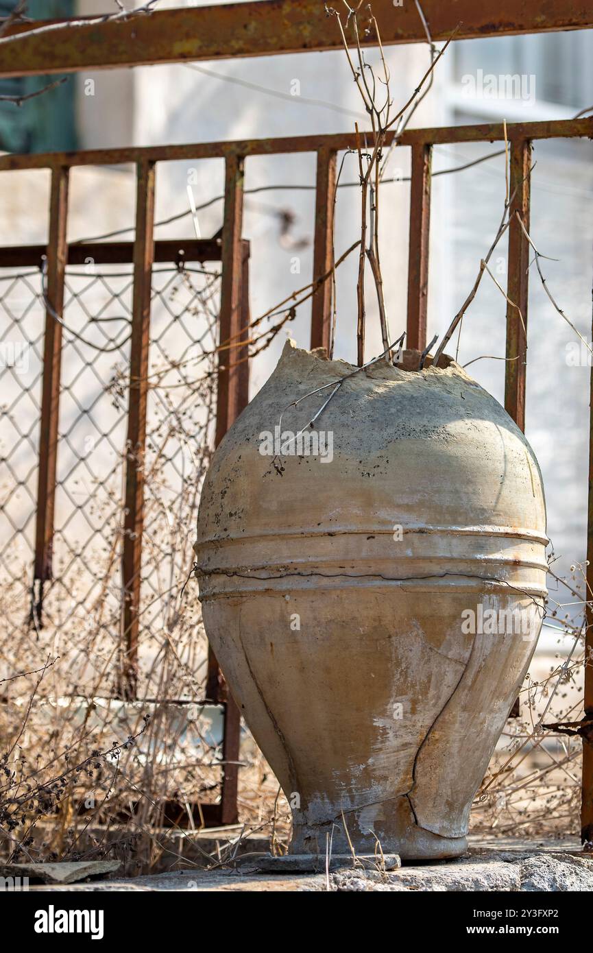 old broken olive jar on balcony of abandoned greek house, derelict ...