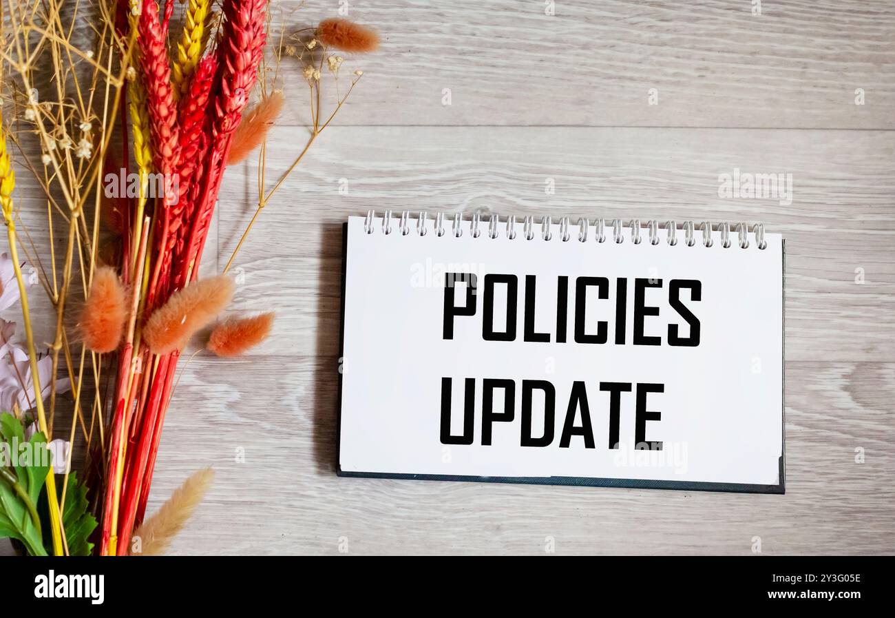 The policy update message is written on a notepad with a beautiful ...