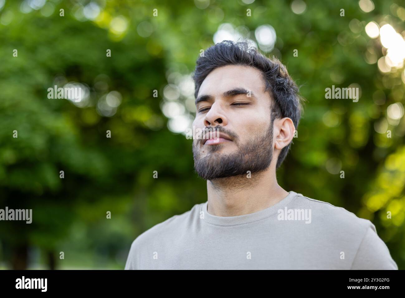 Thoughtful young hispanic man stands hi-res stock photography and ...