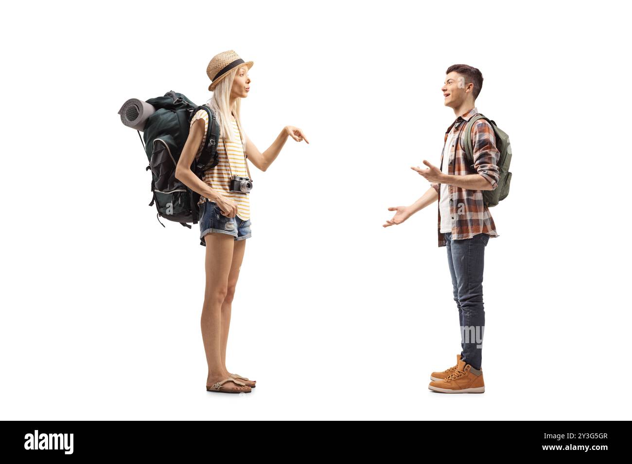 Full length profile shot of a female tourist with a backpack asking a ...