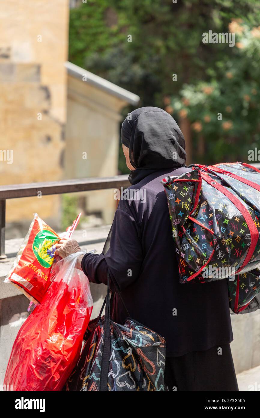 Tbilisi, Georgia - 14 AUG, 2024: Elderly Georgian lady selling items to ...