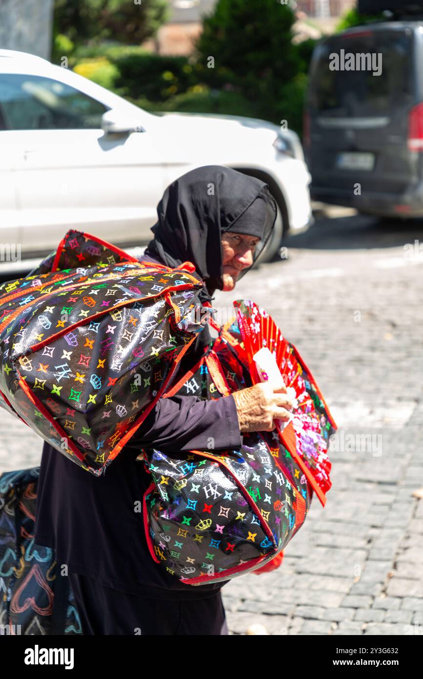 Tbilisi, Georgia - 14 AUG, 2024: Elderly Georgian lady selling items to ...