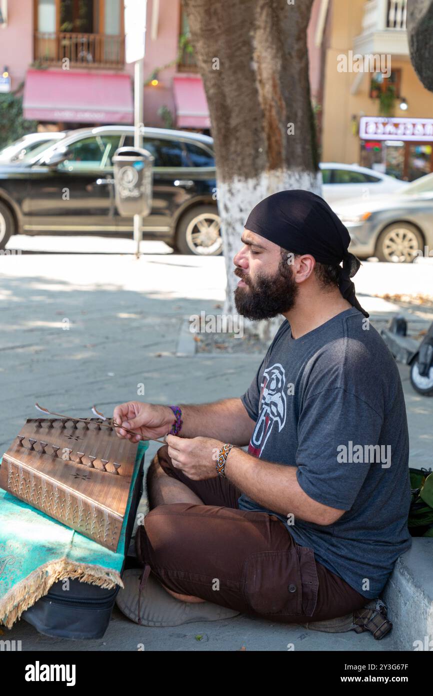 Tbilisi, Georgia - 14 AUG, 2024: Young Iranian musician playing santur ...