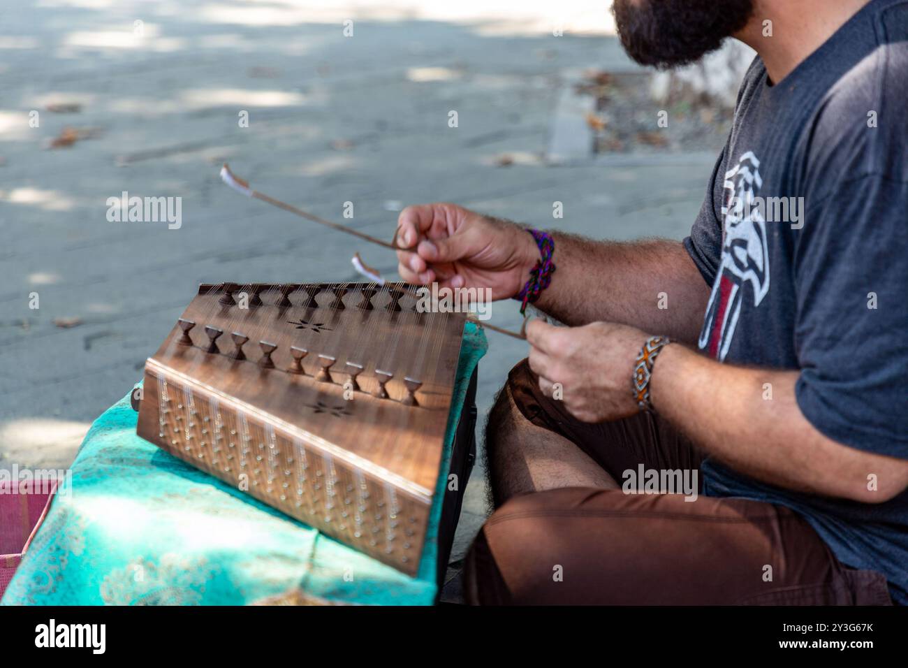 Tbilisi, Georgia - 14 AUG, 2024: Young Iranian musician playing santur ...