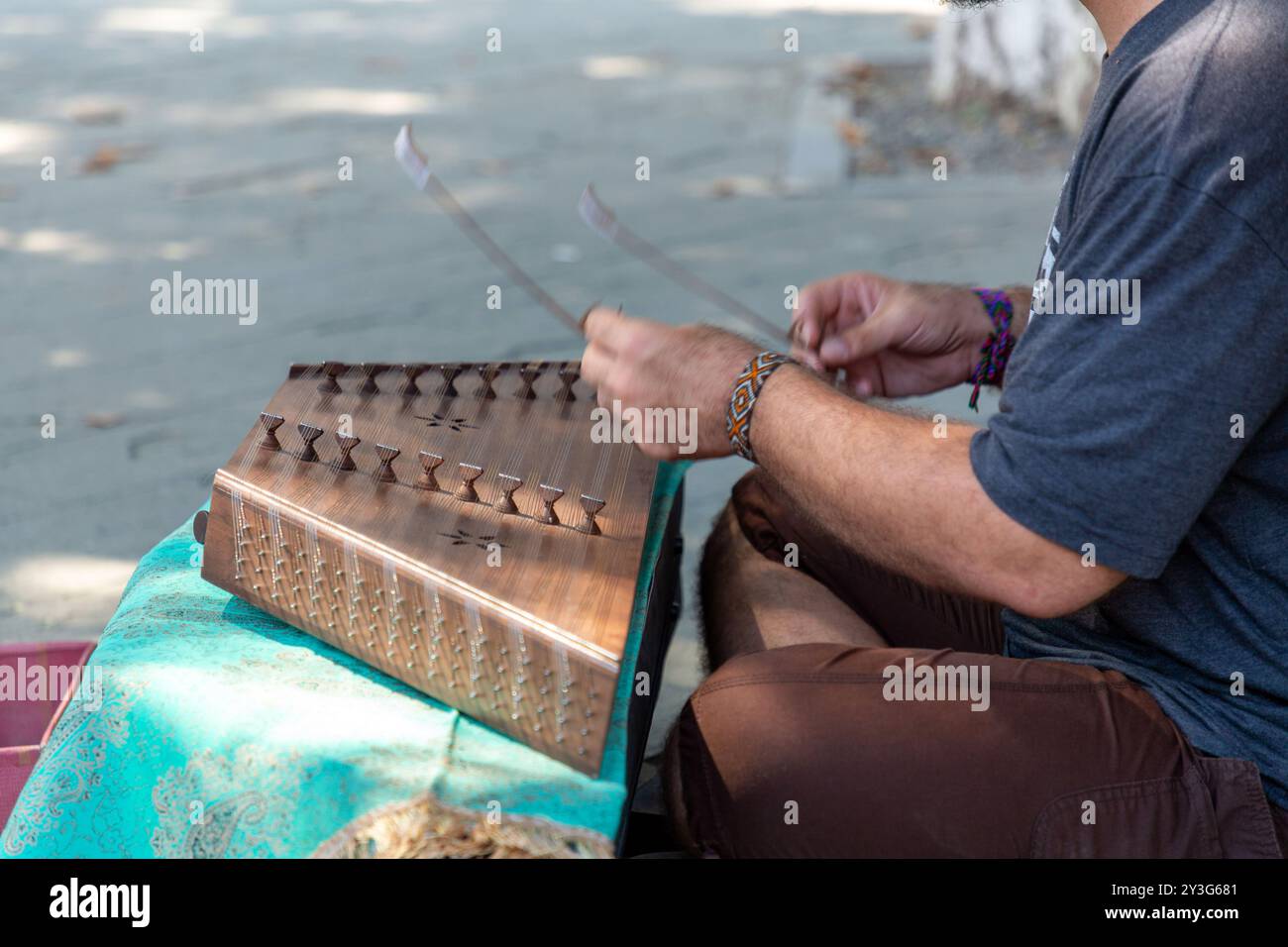 Tbilisi, Georgia - 14 AUG, 2024: Young Iranian musician playing santur ...