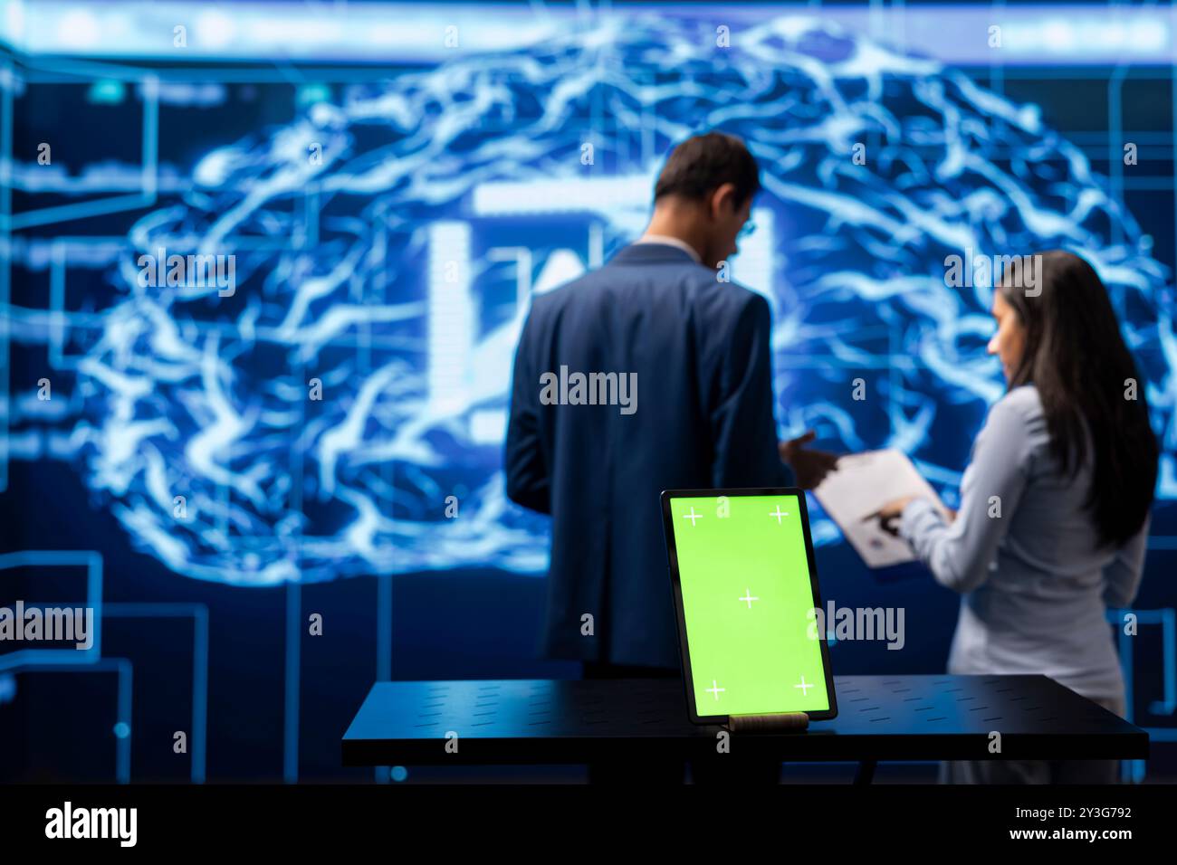 Technicians using green screen tablet and AI neural networks modeled after human brain to solve ...