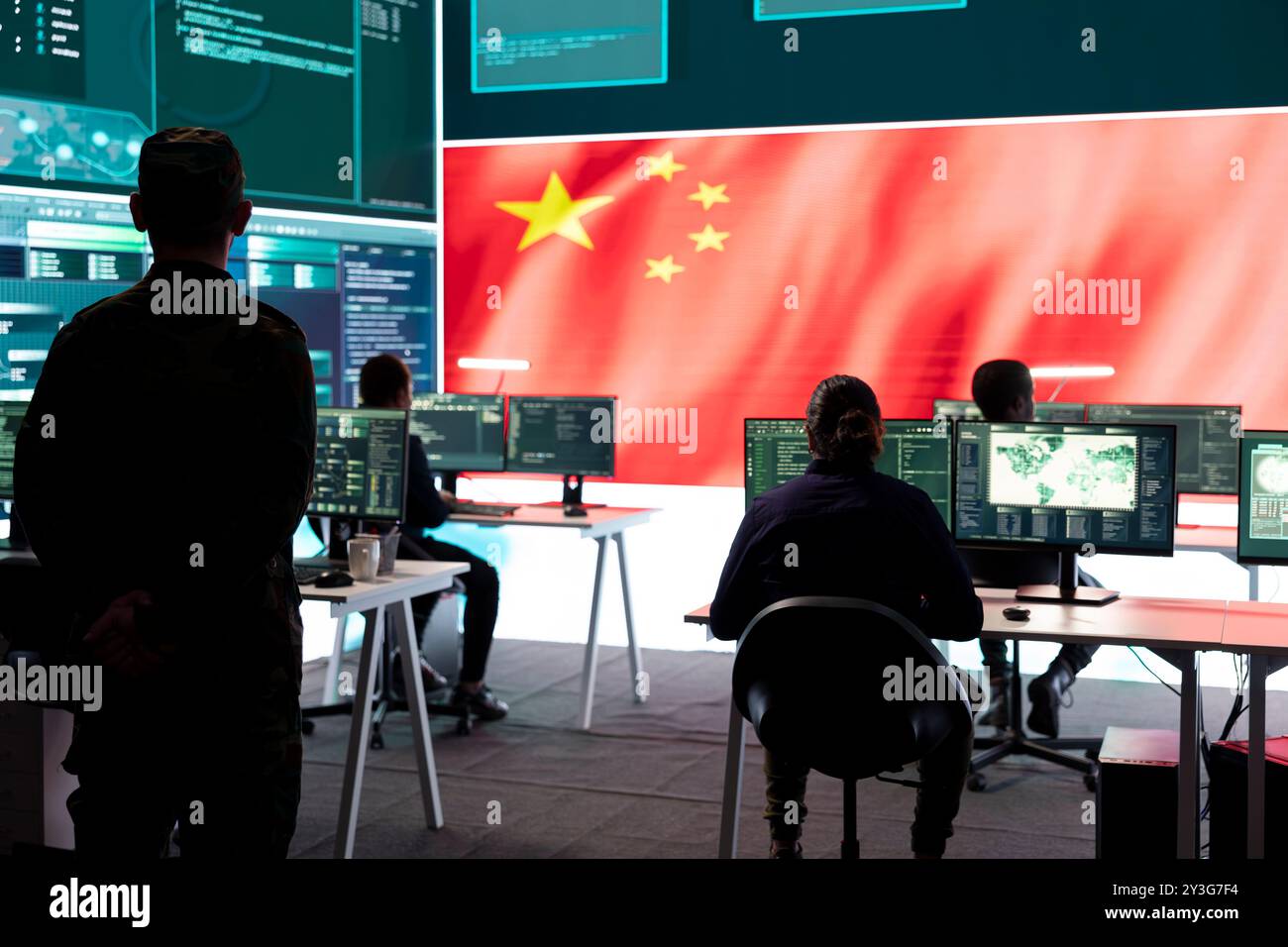 Chinese military personnel in a high tech government hacking room work ...