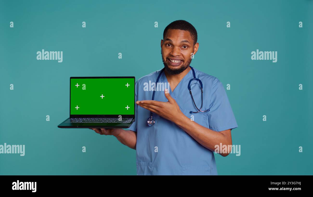 Portrait of practitioner in medical uniform showing instructions on ...
