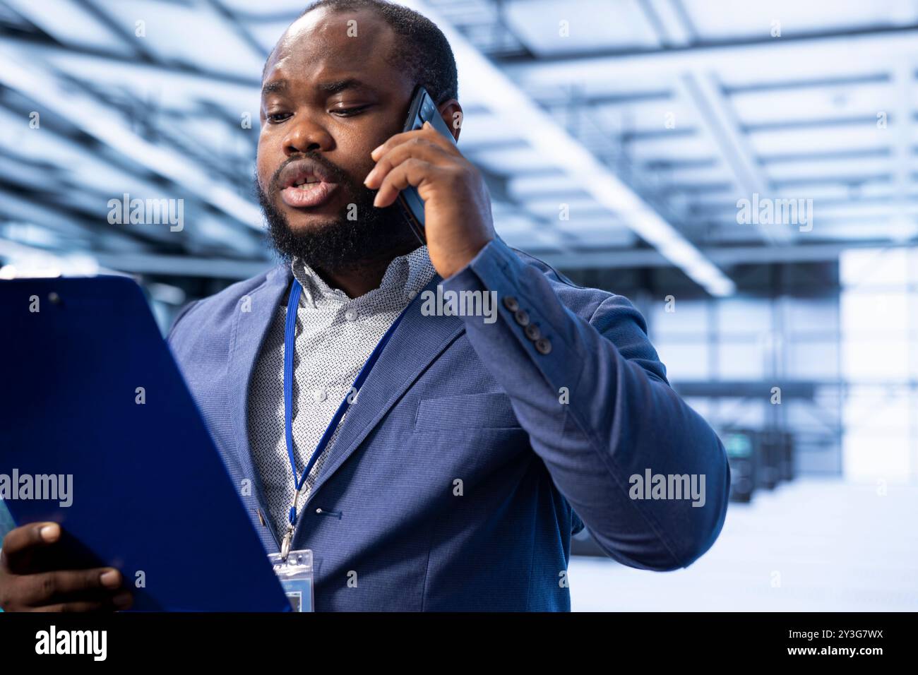 African american man maintaining accurate documentation of data center ...