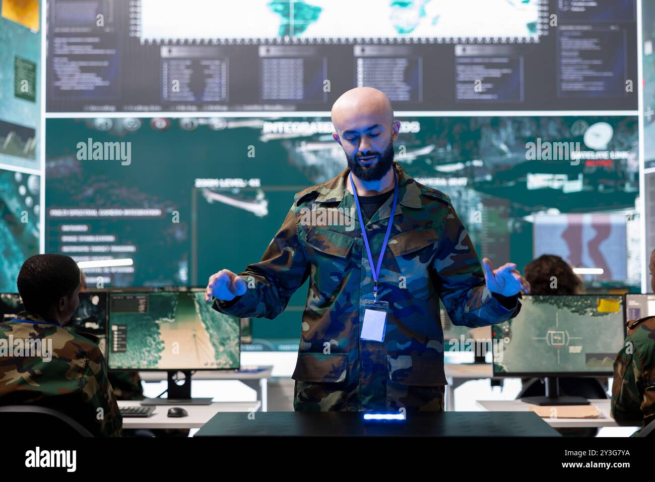 Military personnel studying a projection on hologram in command post ...