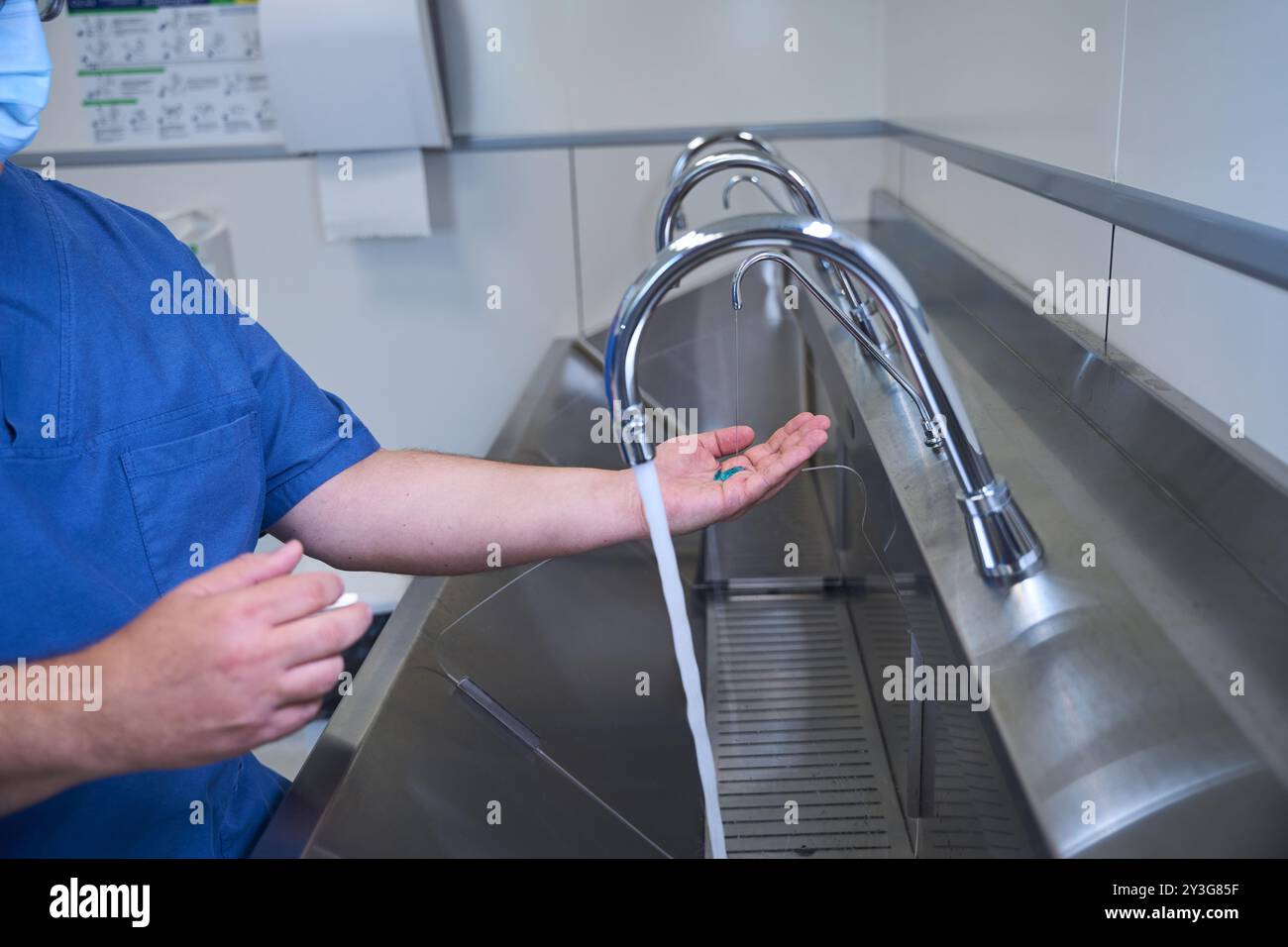 Close-up of doctor rinsing hands under water Stock Photo - Alamy