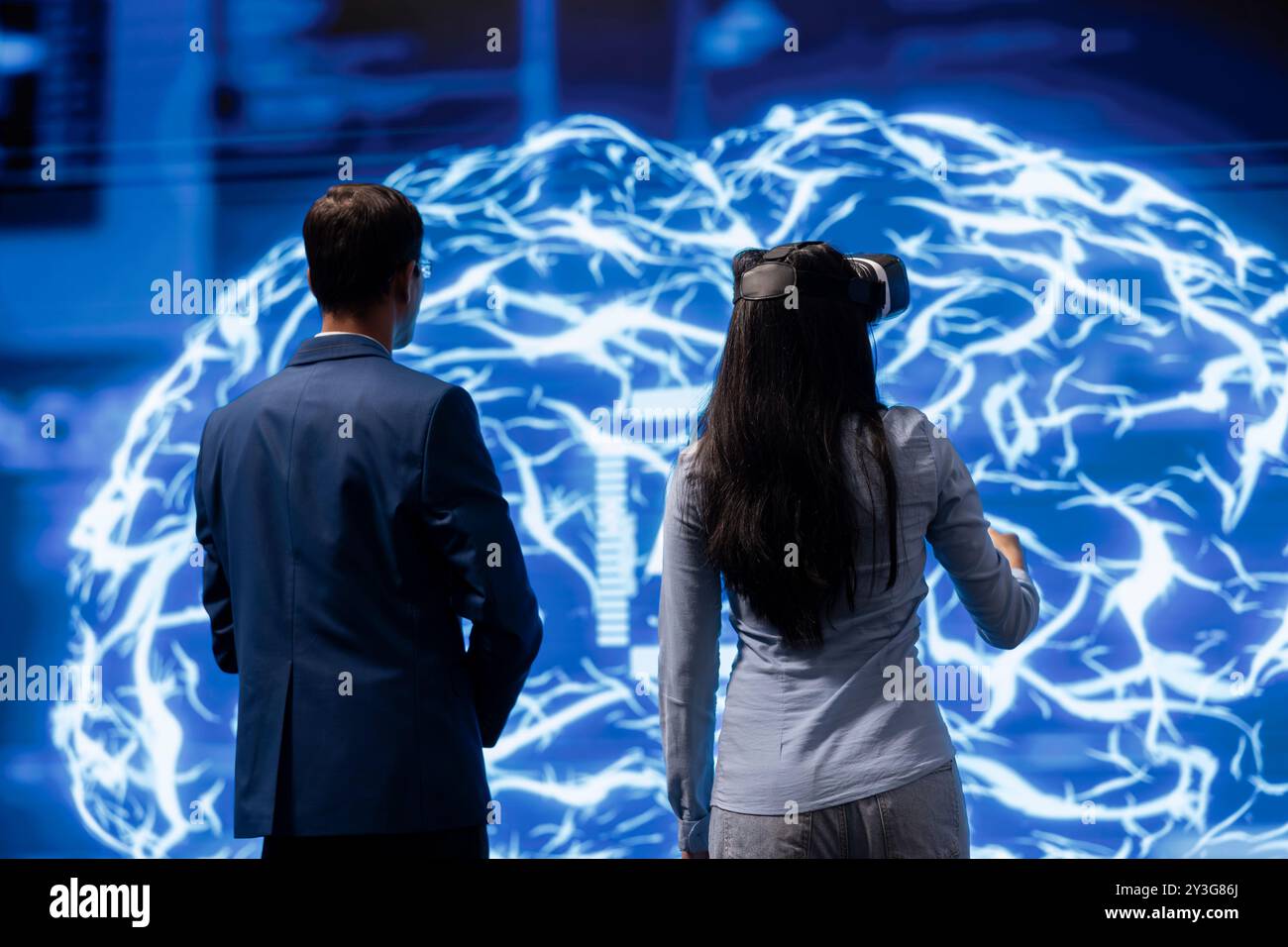 Engineer wearing VR headset and coworker working with artificial ...