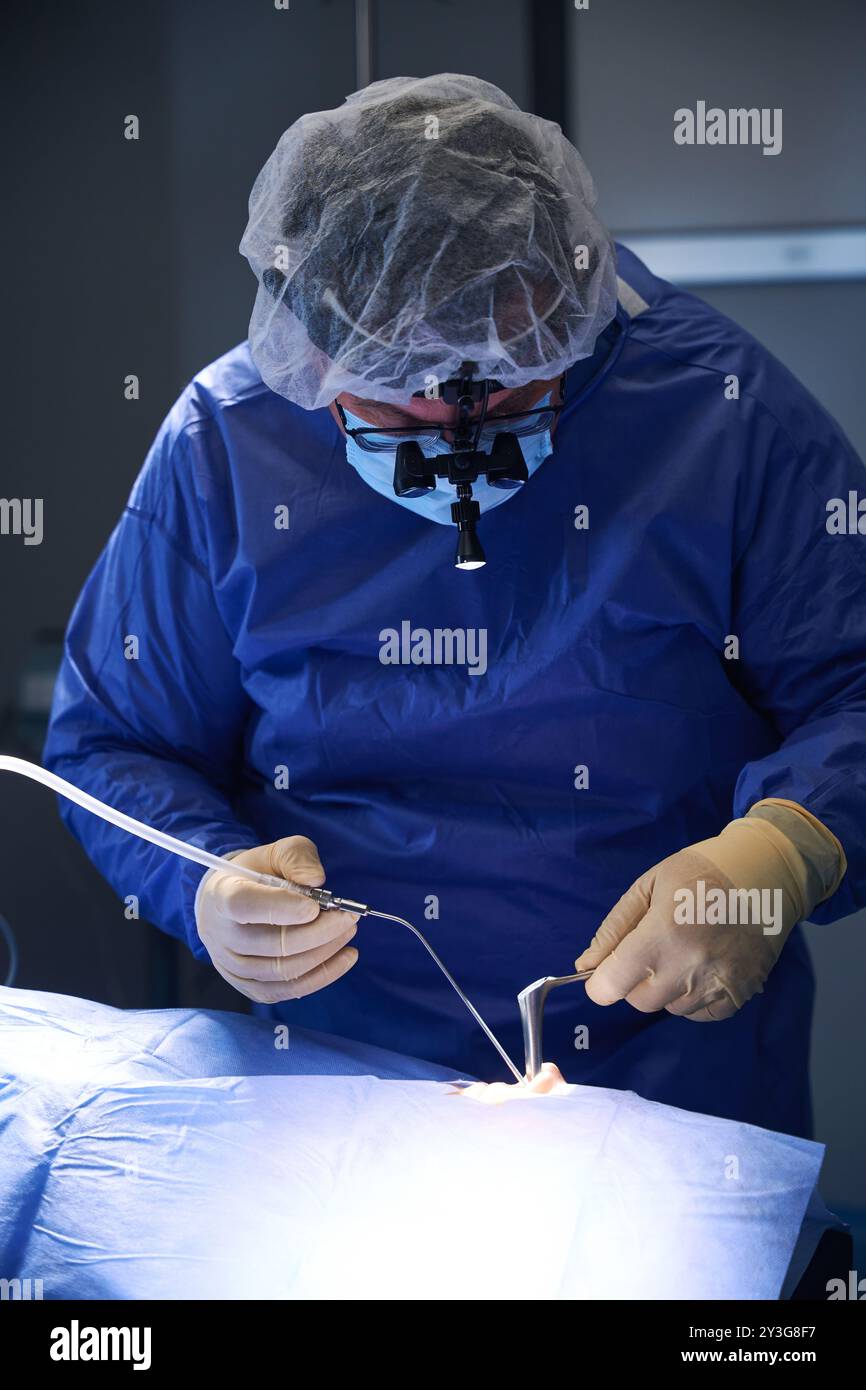 Medic remains focused while carefully handling surgical instruments ...