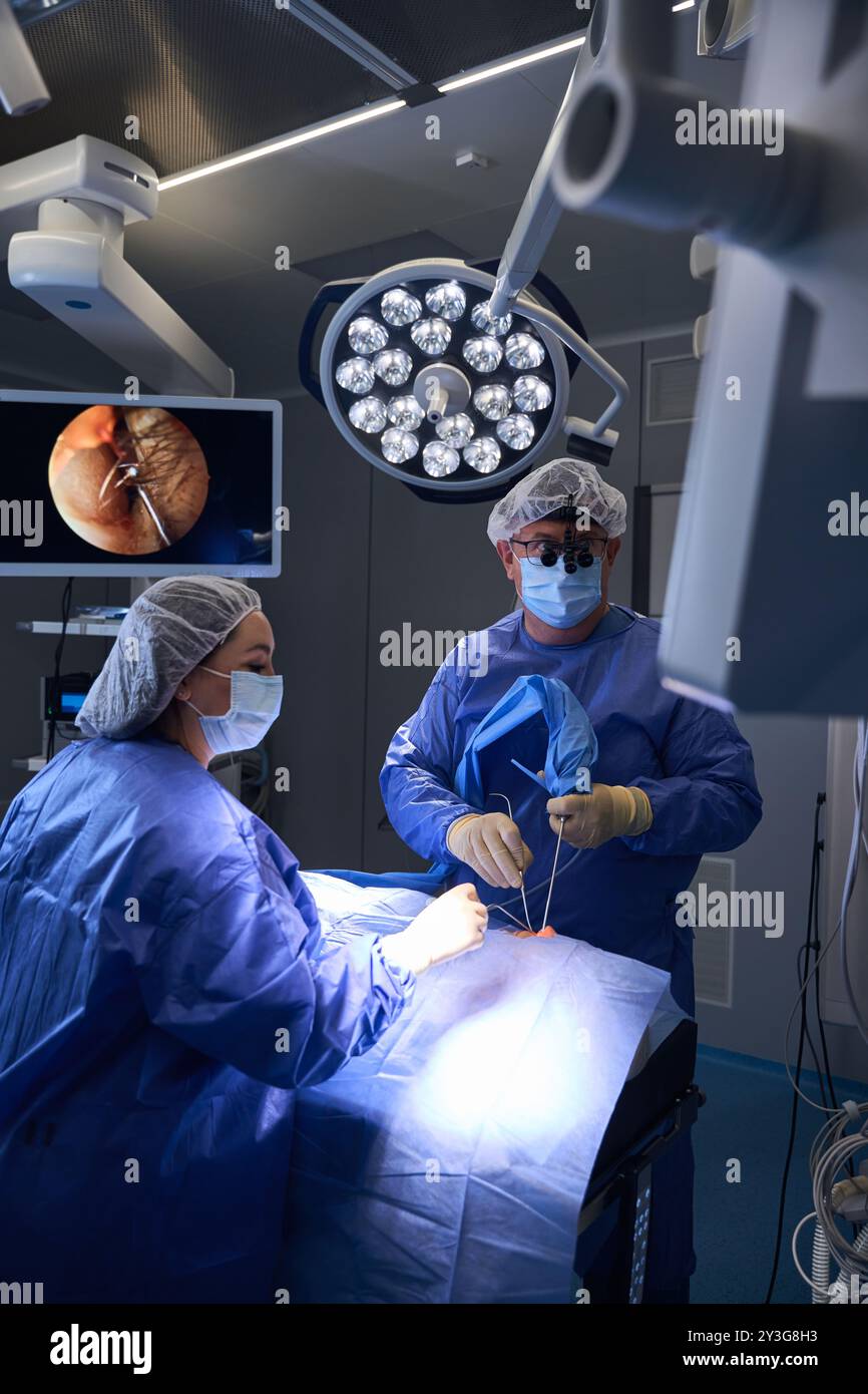 Doctor adjusting special equipment hi-res stock photography and images ...