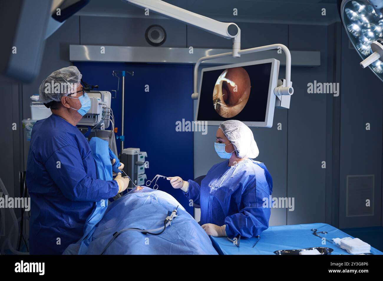 Surgeons reviewing medical data on screen during surgery Stock Photo ...