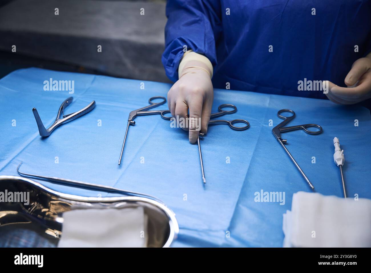 Surgeon selecting tools for upcoming surgery Stock Photo - Alamy