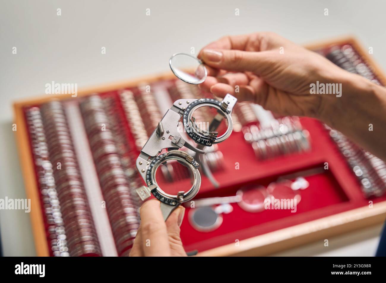 Hand adjusting lenses in a trial frame Stock Photo - Alamy