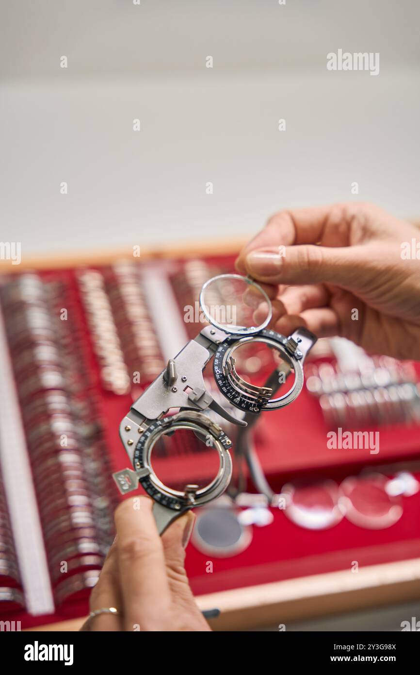 Hand holding a trial frame for lens testing Stock Photo - Alamy