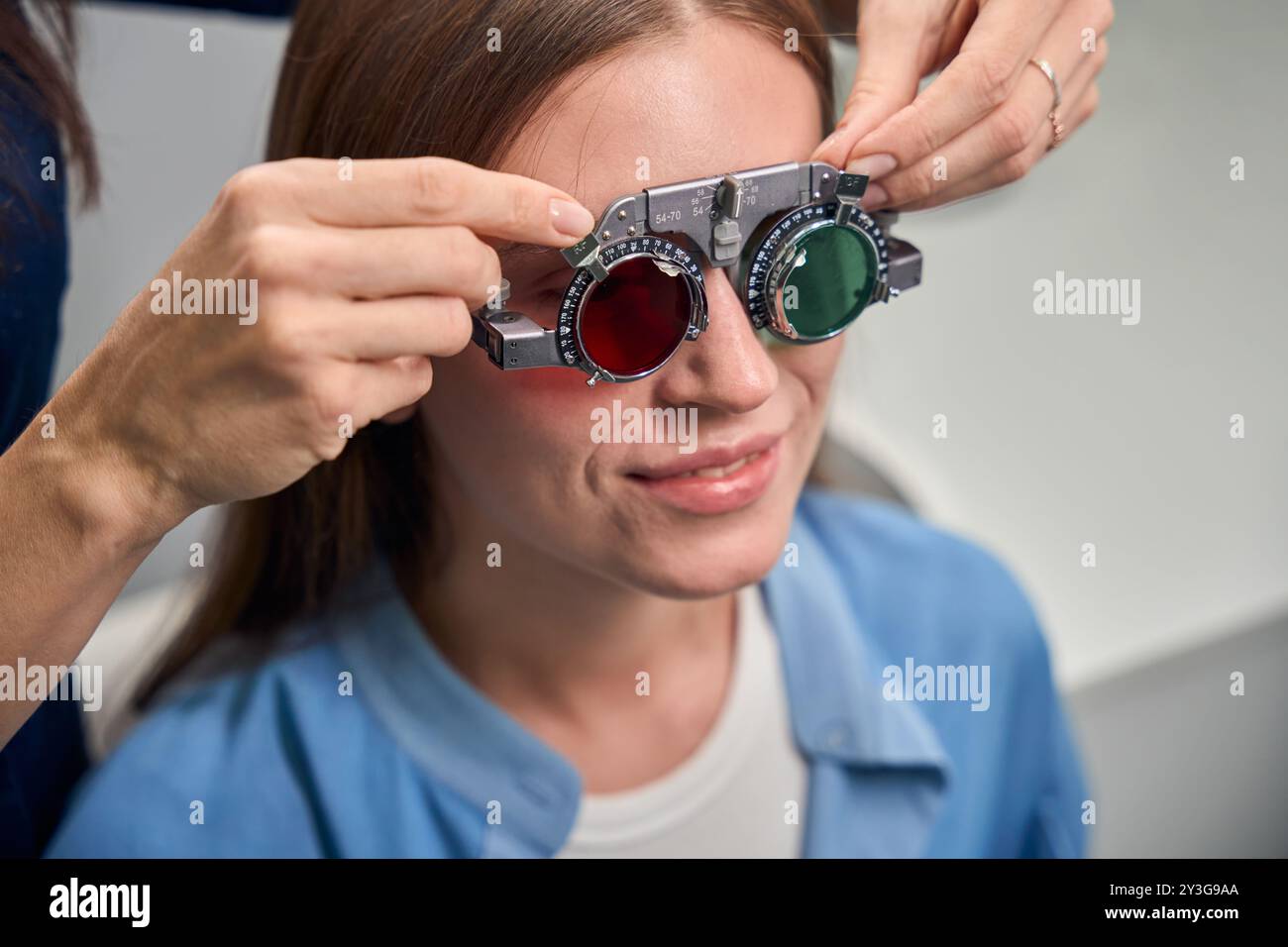 Patient wearing trial frame during eye exam Stock Photo - Alamy