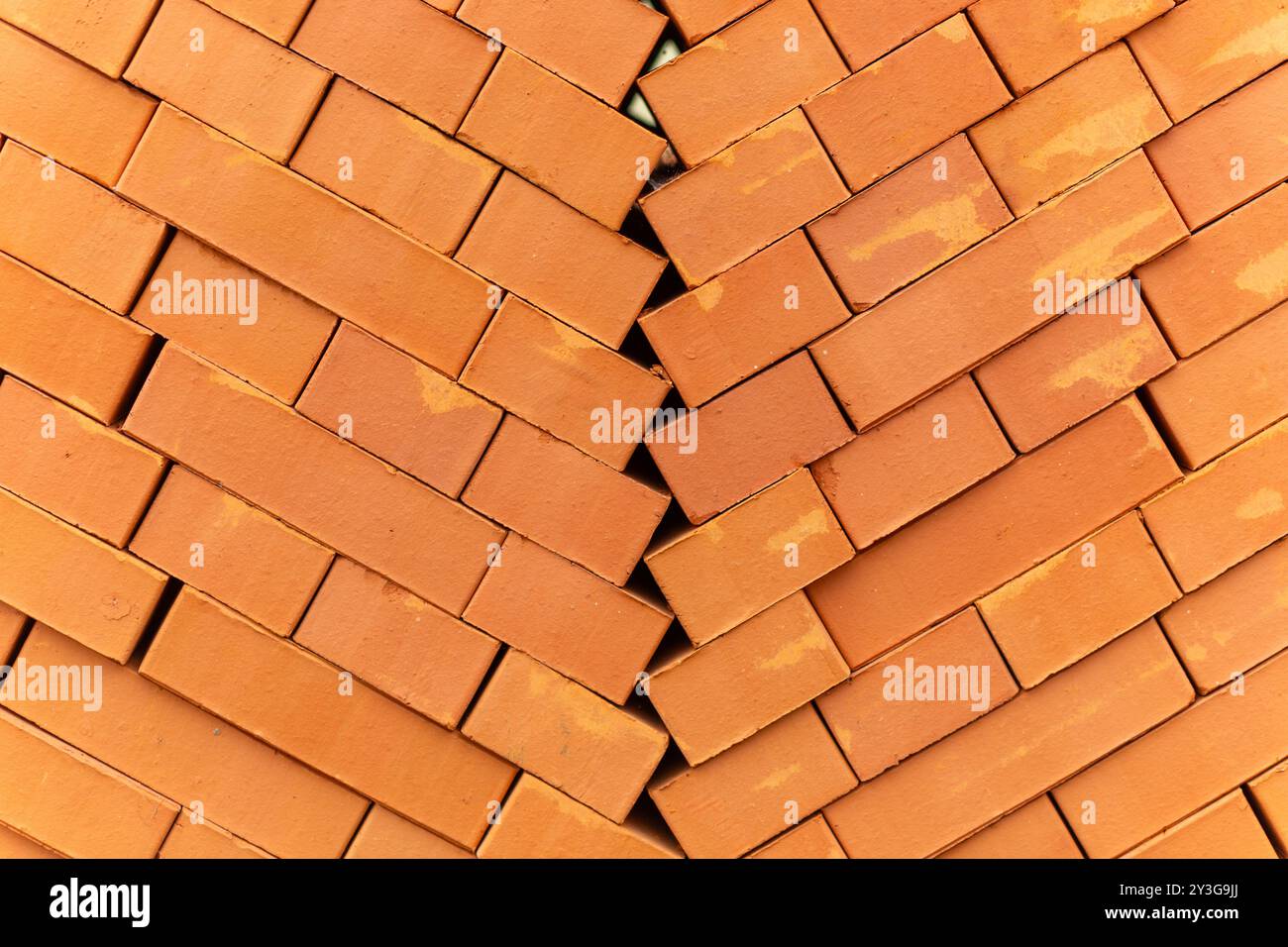 Stacks of new, red ceramic brick stacked on wooden pallets. Lots of new ...