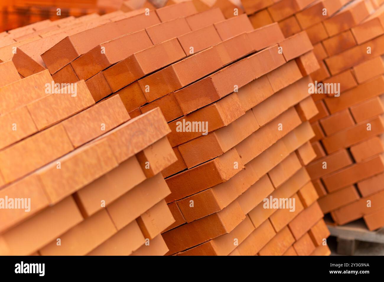 Stacks of new, red ceramic brick stacked on wooden pallets. Lots of new ...