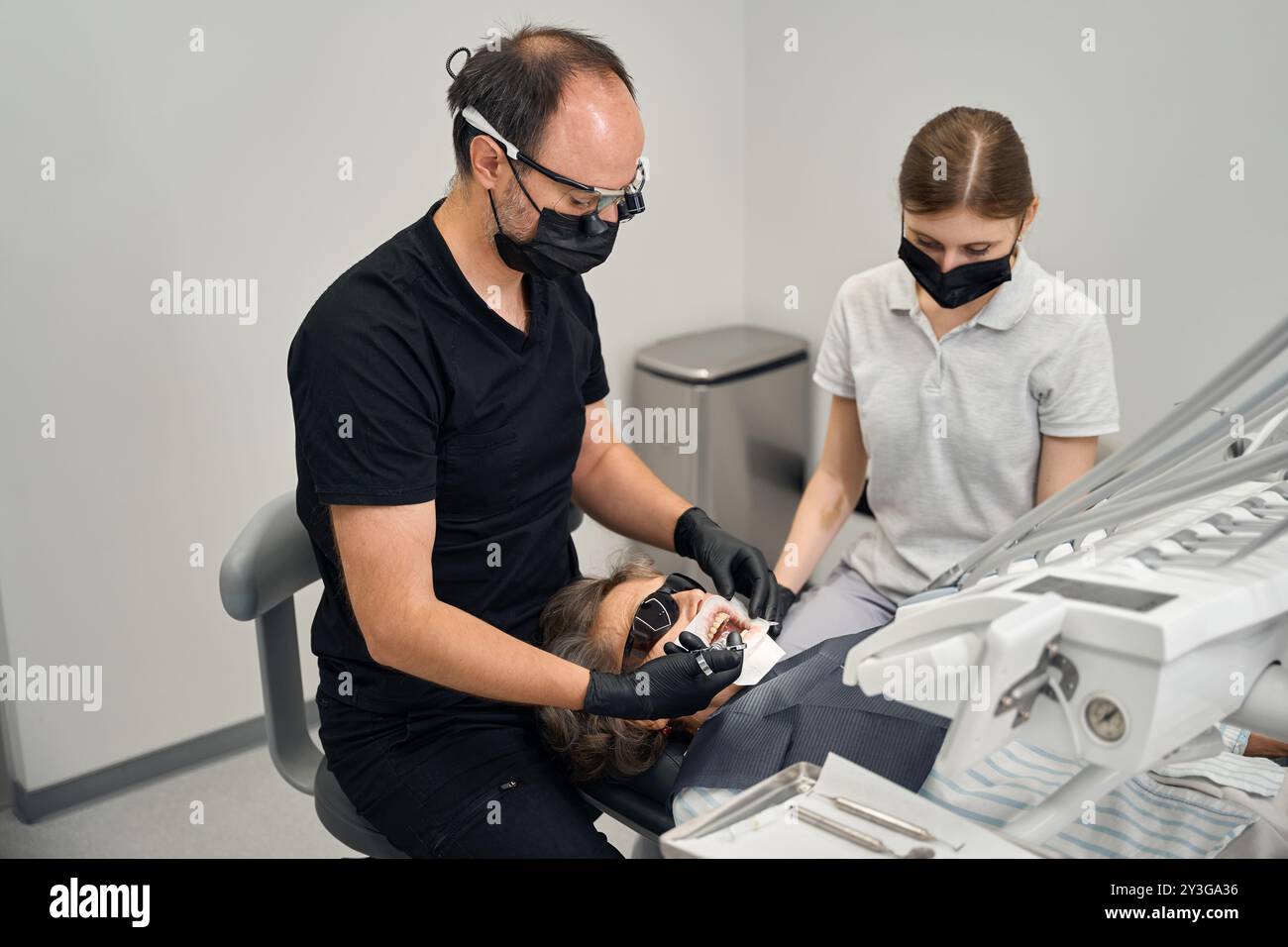 Dentist gives a lady an anesthetic injection with special syringe Stock ...