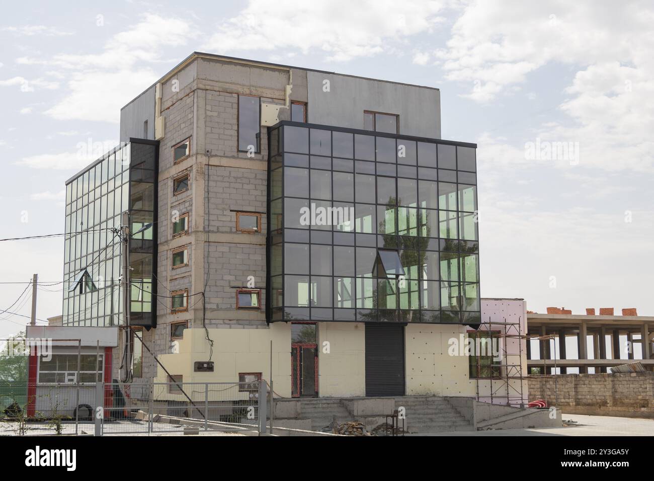 A new building in the center of the town, has glass windows and ...