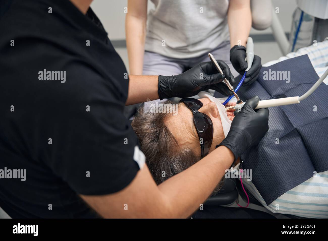 Lady is getting her teeth treated at a dental clinic Stock Photo - Alamy