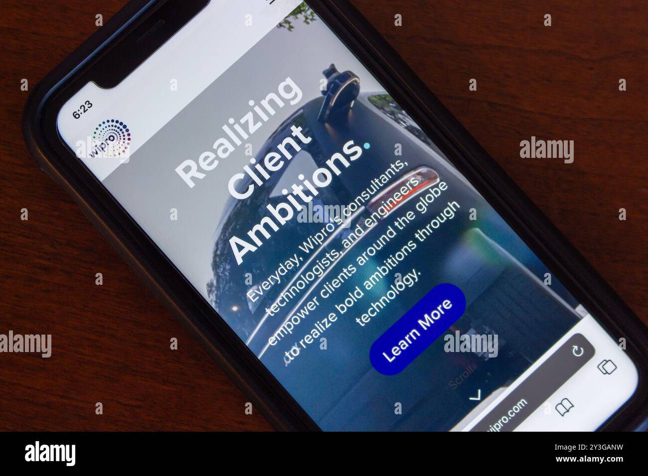 Wipro website is displayed in an iPhone screen. Wipro is an India-based ...