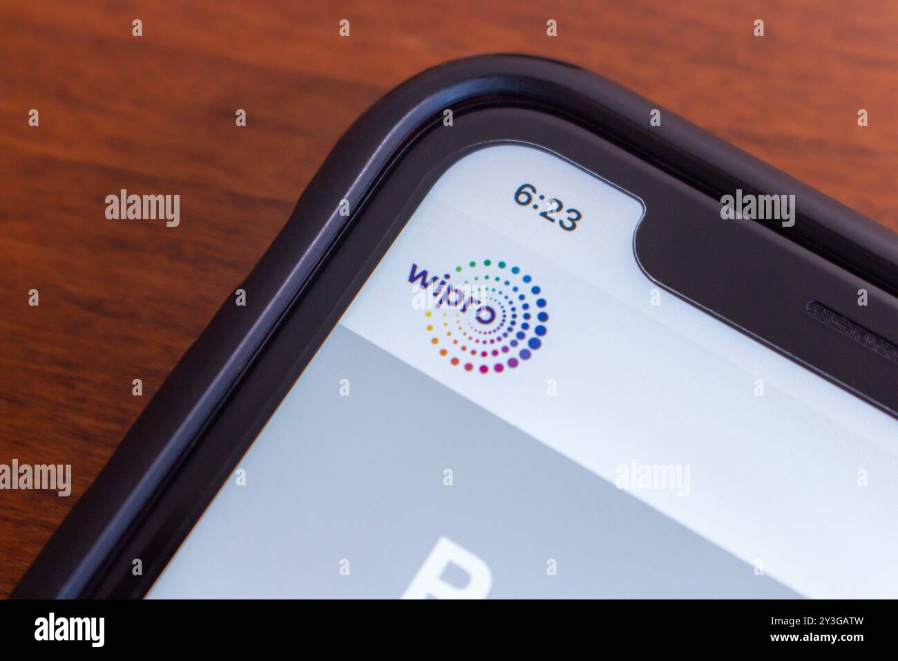 Wipro website is displayed in an iPhone screen. Wipro is an India-based ...
