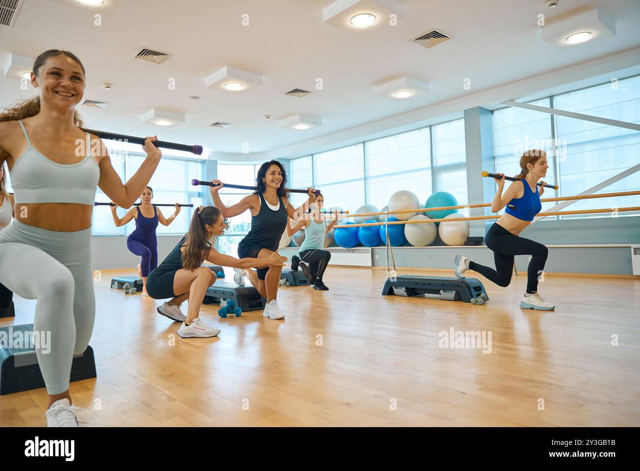 Health group exercises with gymnastic sticks in the training room Stock ...