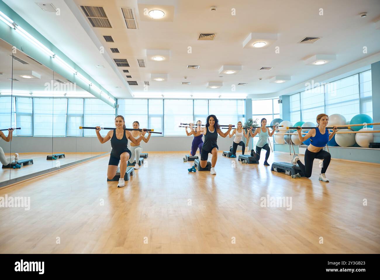 Women perform a set of exercises with gymnastic sticks Stock Photo - Alamy