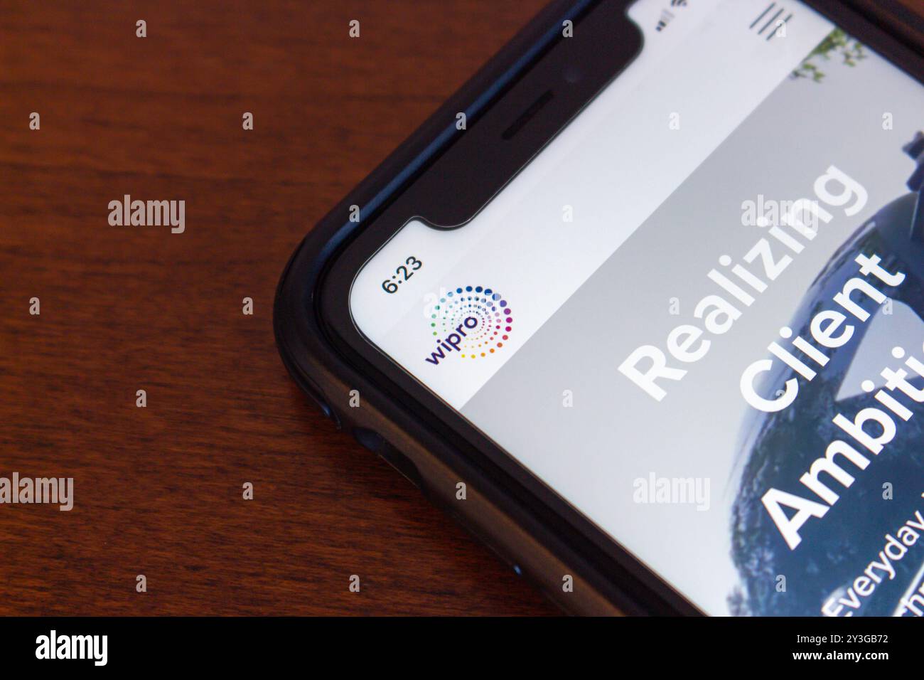 Wipro website is displayed in an iPhone screen. Wipro is an India-based ...