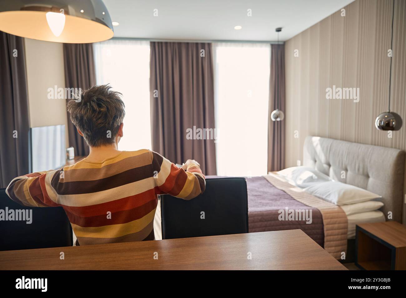 Back view of adult woman posing in hotel room Stock Photo - Alamy