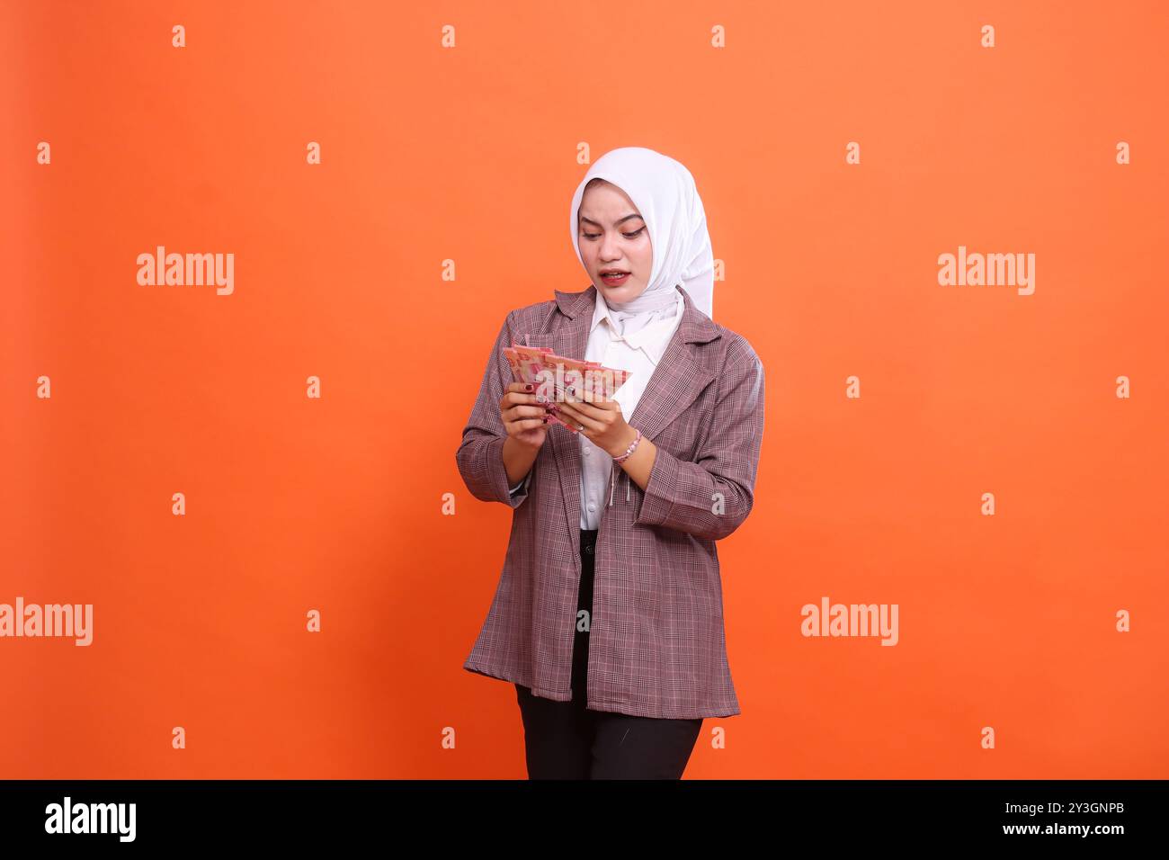 Charm of beautiful Asian woman wearing hijab shocked both hands holding ...