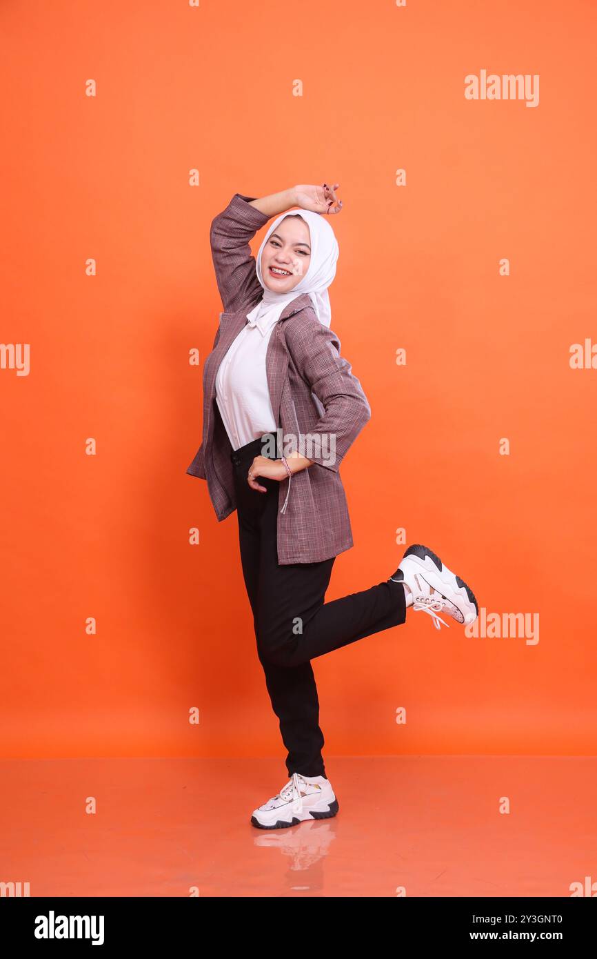 Full length portrait of beautiful Muslim indonesia woman model dancing ...