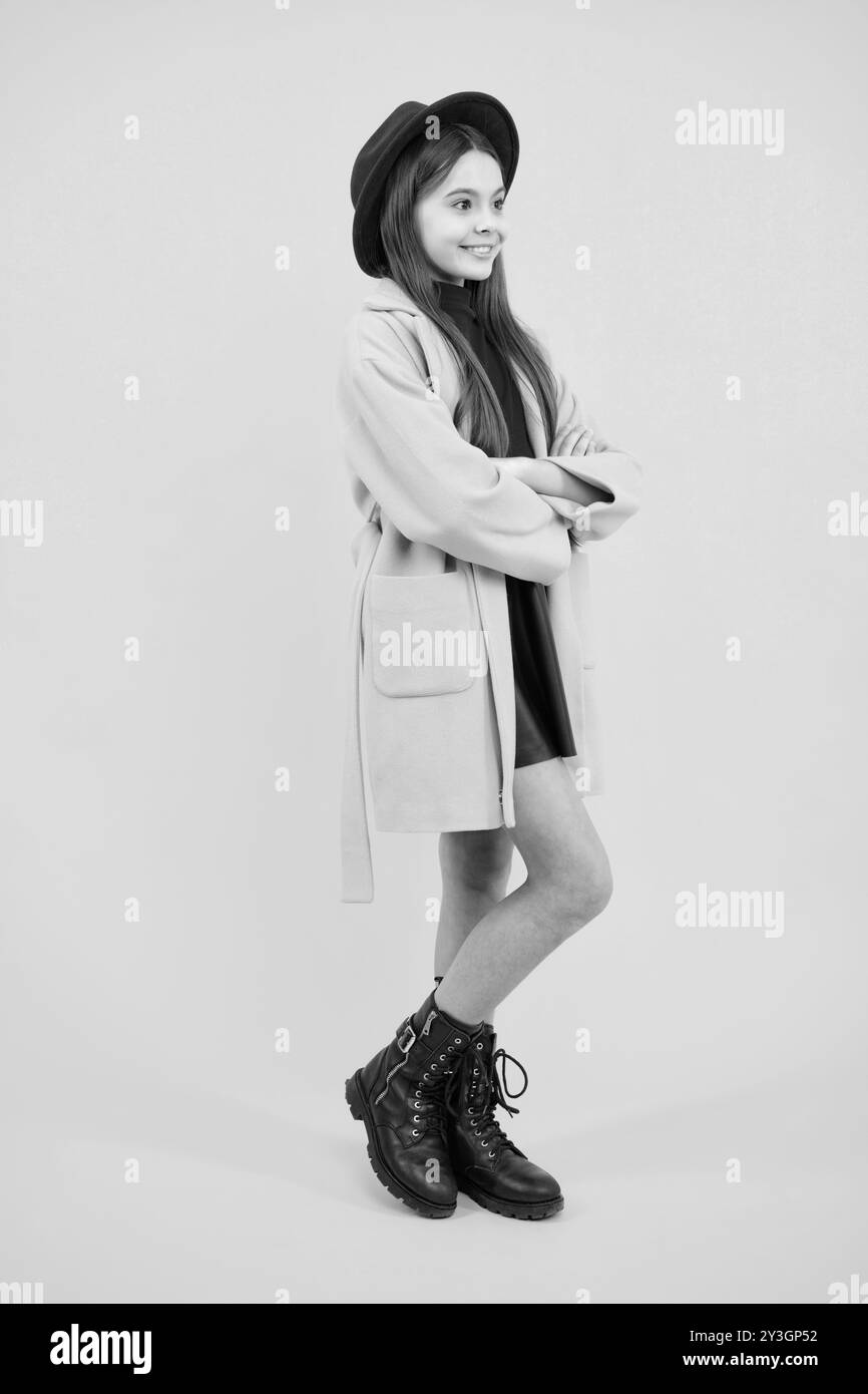 Autumn clothes. Full length of cheerful teenager child girl wearing ...