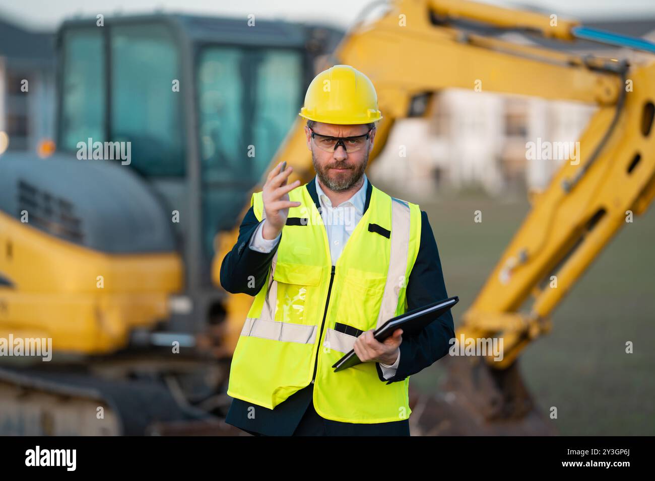 Construction business owner. Man in suit and hardhat halmet at building ...