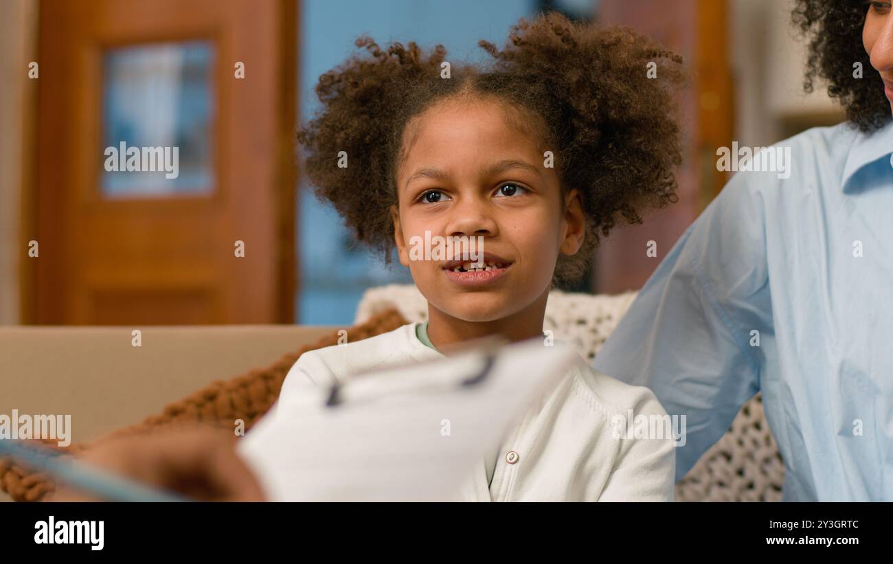 African American happy little girl child daughter tell say talk ...