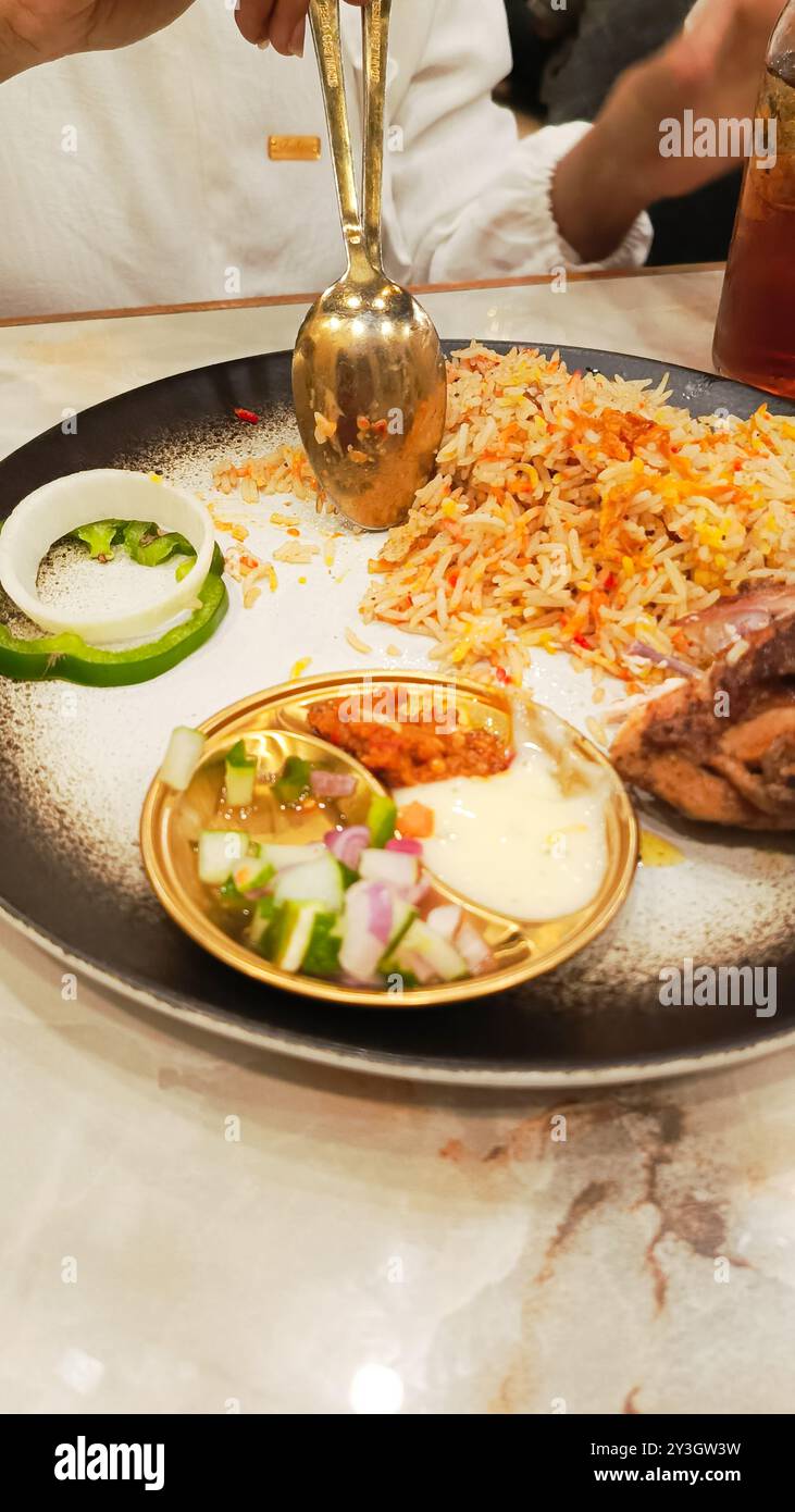 portrait of asian woman's hand scraping rice with spoon and fork on ...